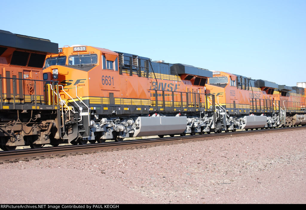 BNSF 6631 and BNSF 6629 two Very Brand New ES44C4's glistening in the sun's rays as they wait to ...